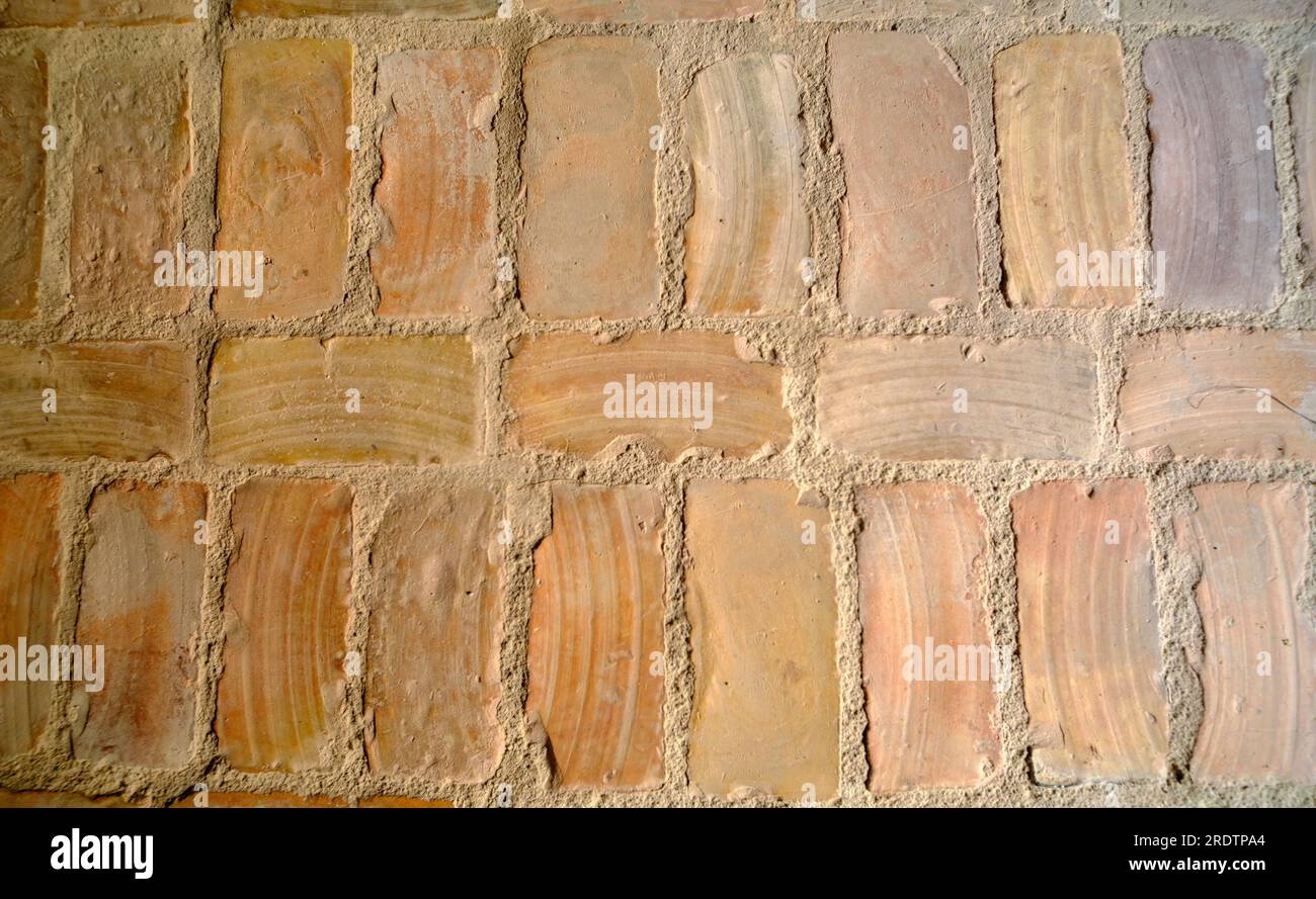 Close-up of an old brick-paved farm interior. Clay brick paving pattern ...