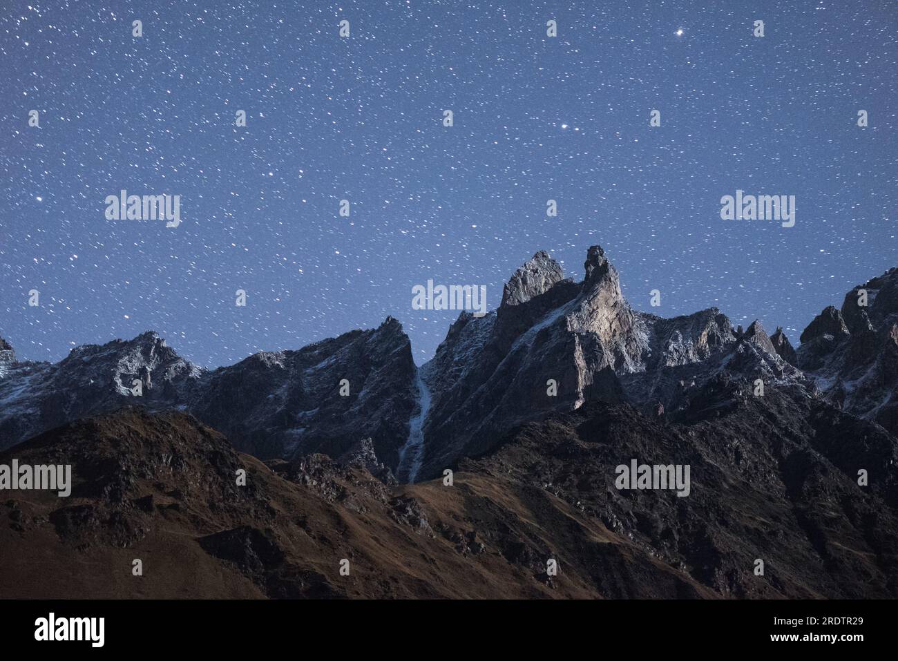 Night landscape. Mountain top and the starry sky. Moonlight on the ...
