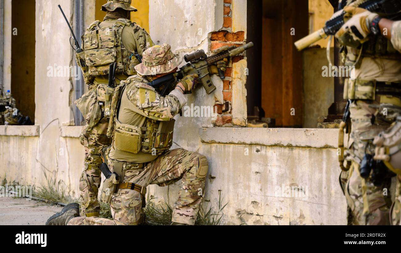 Smart teamwork of soldiers running forward and attacking enemy during ...