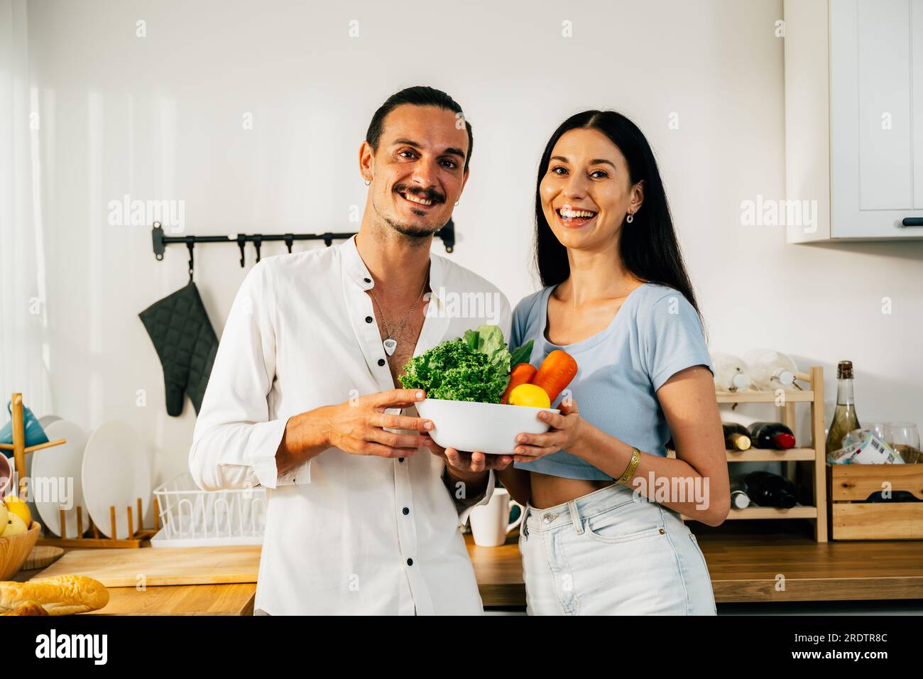 Healthy lovers cooking food in kitchen, Happy young couple spending ...