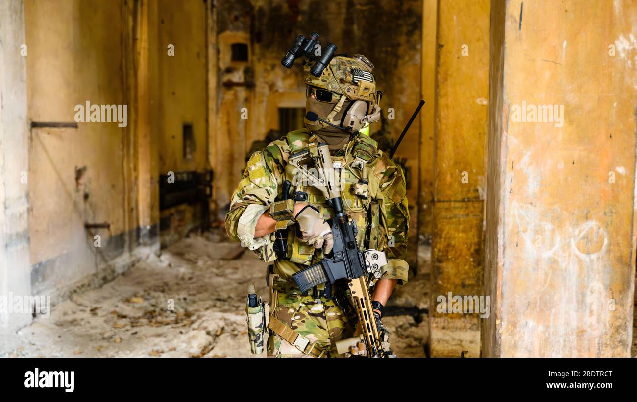 Expert team of soldiers with weapons attacking enemy during military ...