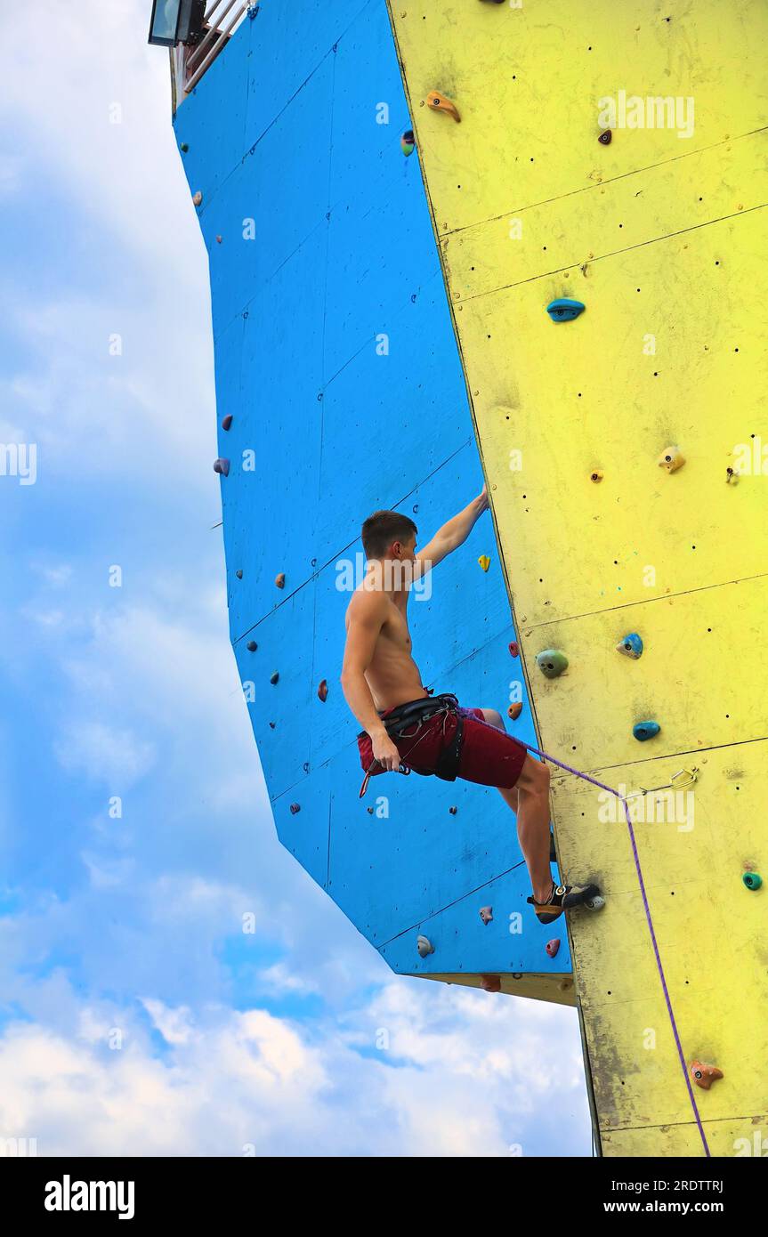 Climber hanging on a rope on the sky background Stock Photo - Alamy