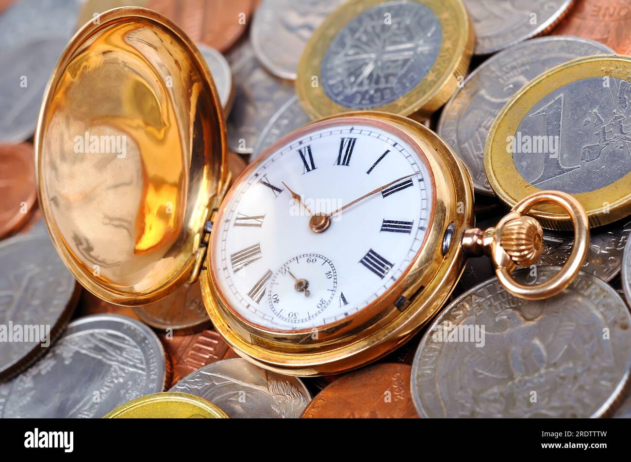 Pocket gold watch and coins, close up Stock Photo - Alamy