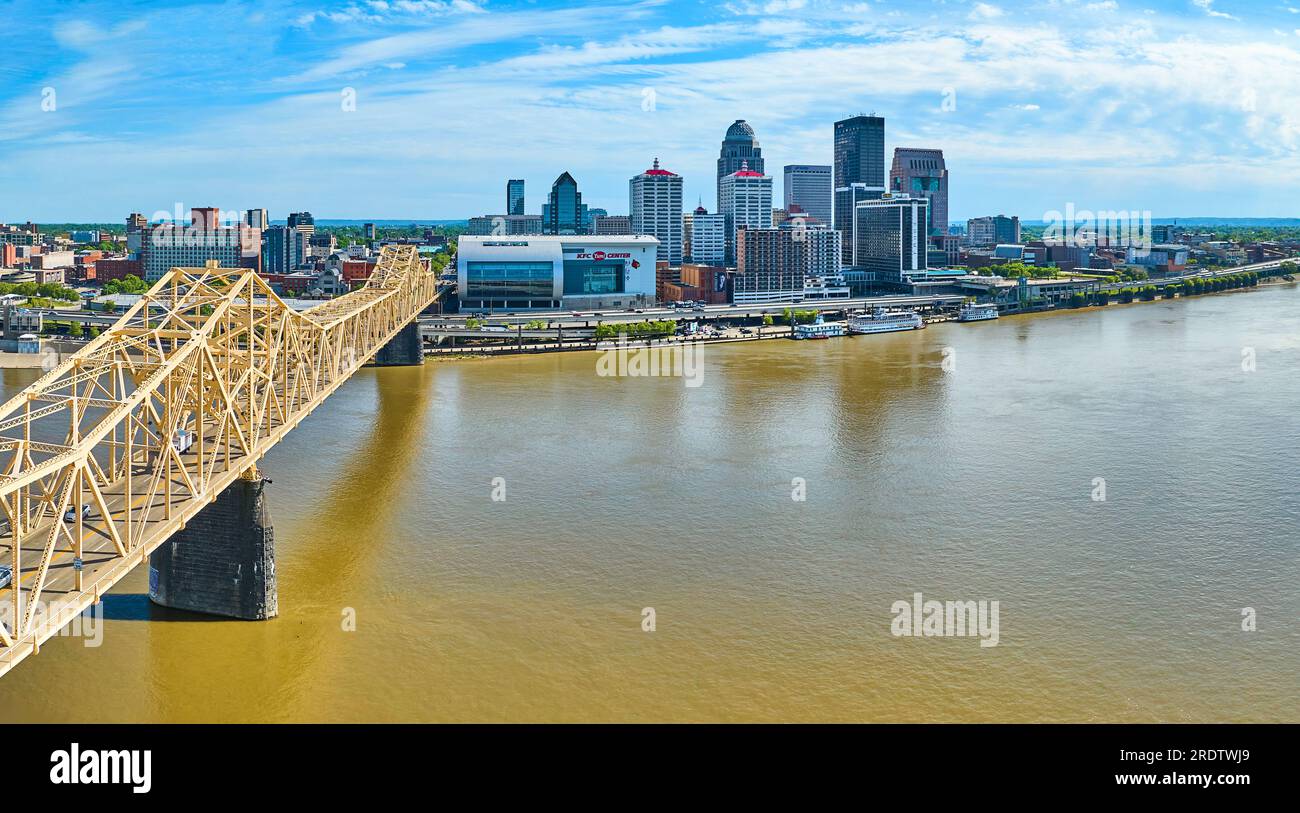 Panoramic aerial rose gold truss bridge over Ohio River heading into ...
