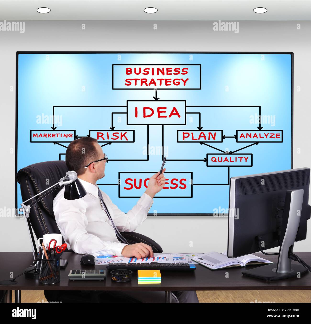 businessman sitting in office and pointing to business scheme Stock ...
