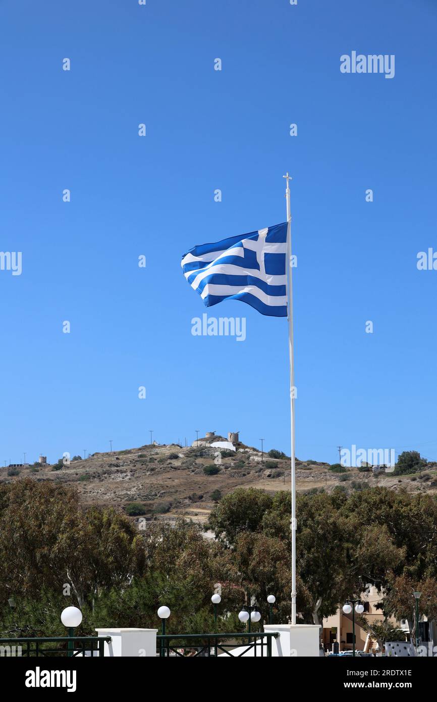 Greek flag on flagpole of the Cyclades Island-Santorini-Greece Stock ...