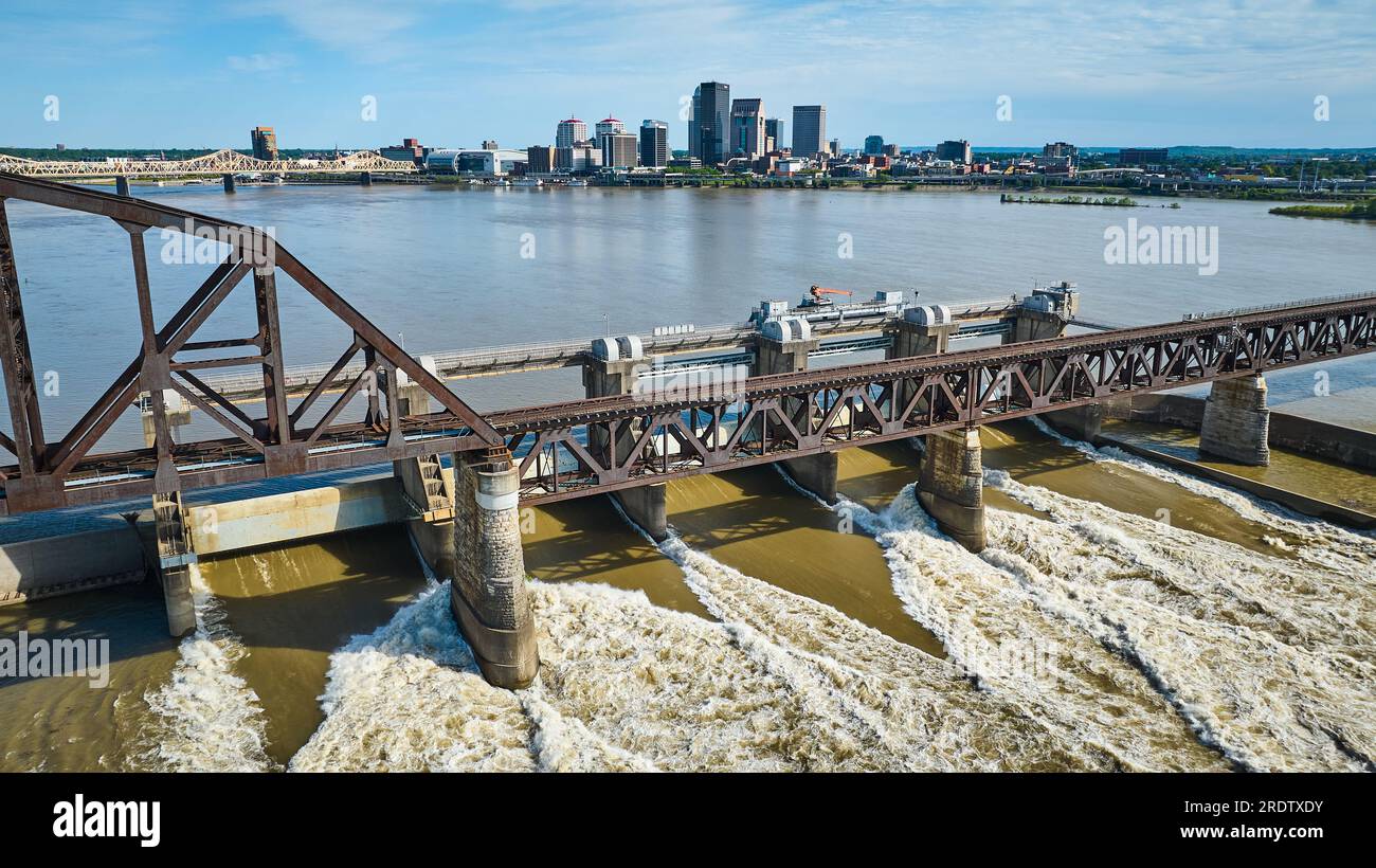 Aerial brown truss arch bridge over dam in Ohio River white water ...
