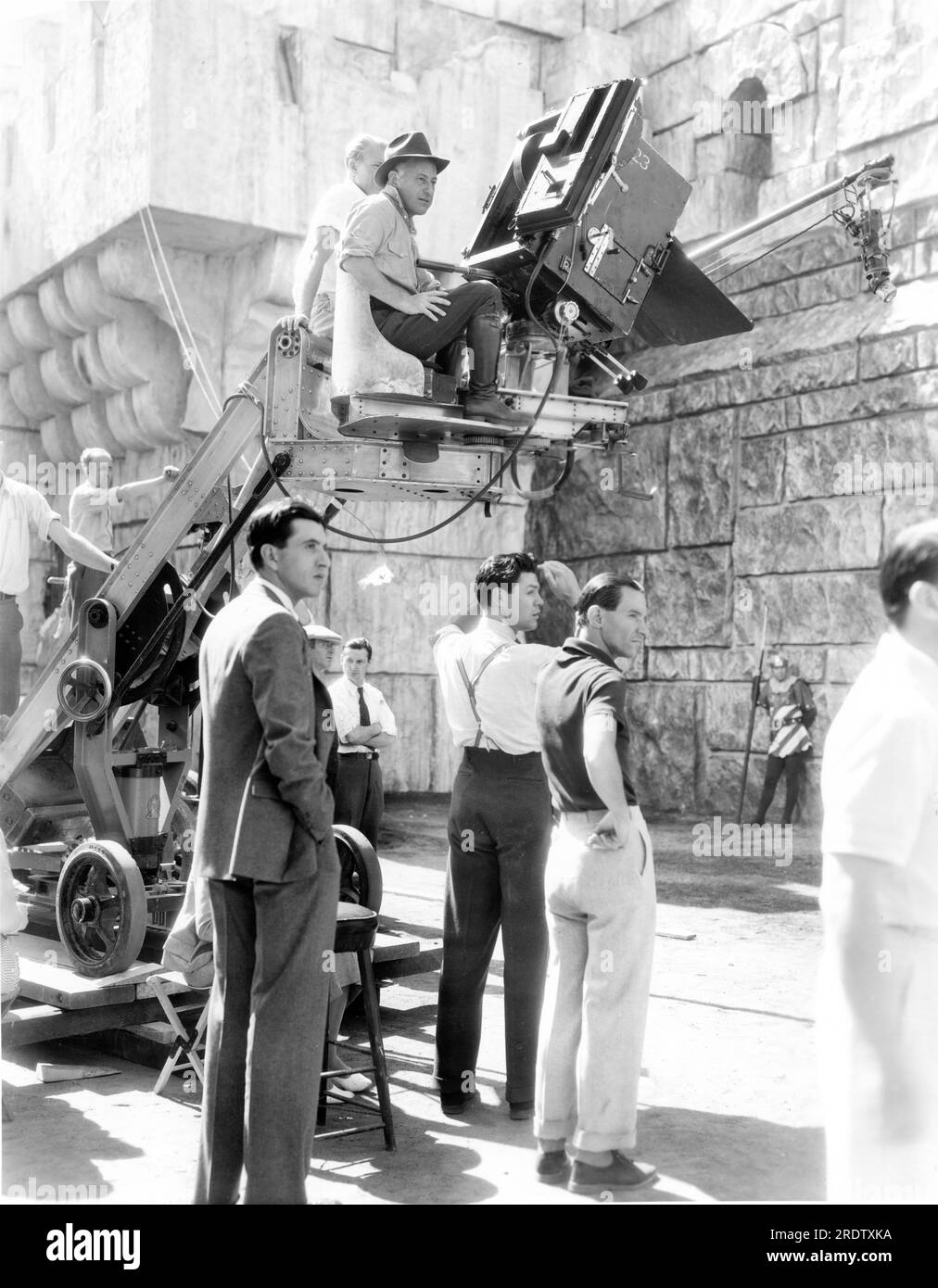 Director CECIL B. DeMILLE on camera crane with below him Assistant ...