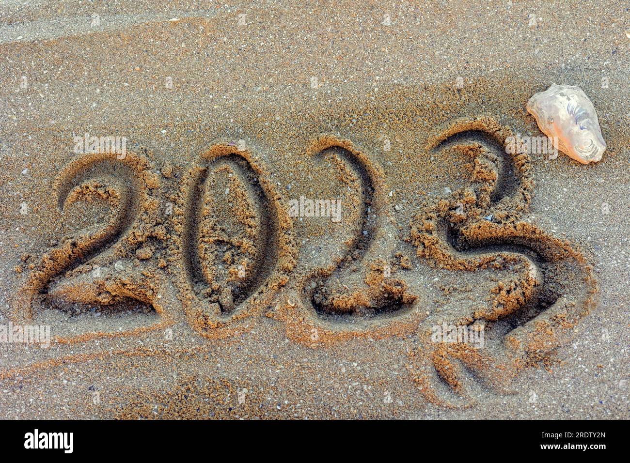Happy New Year 2023, lettering message handwritten on the beach Numbers ...