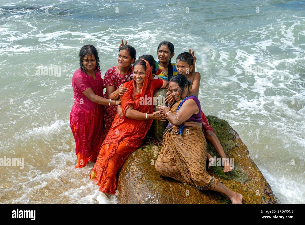 Tourists enjoying sea water bathing at the meeting confluence point of three seas Bay of Bengal ...