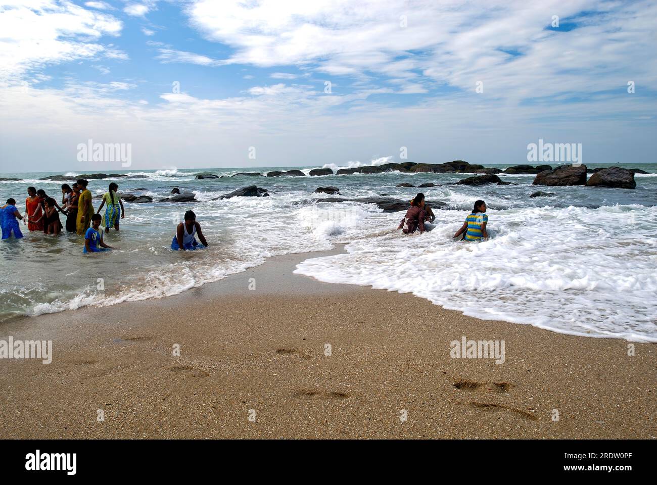 Tourists bathing at the meeting point of three seas Bay of Bengal ...