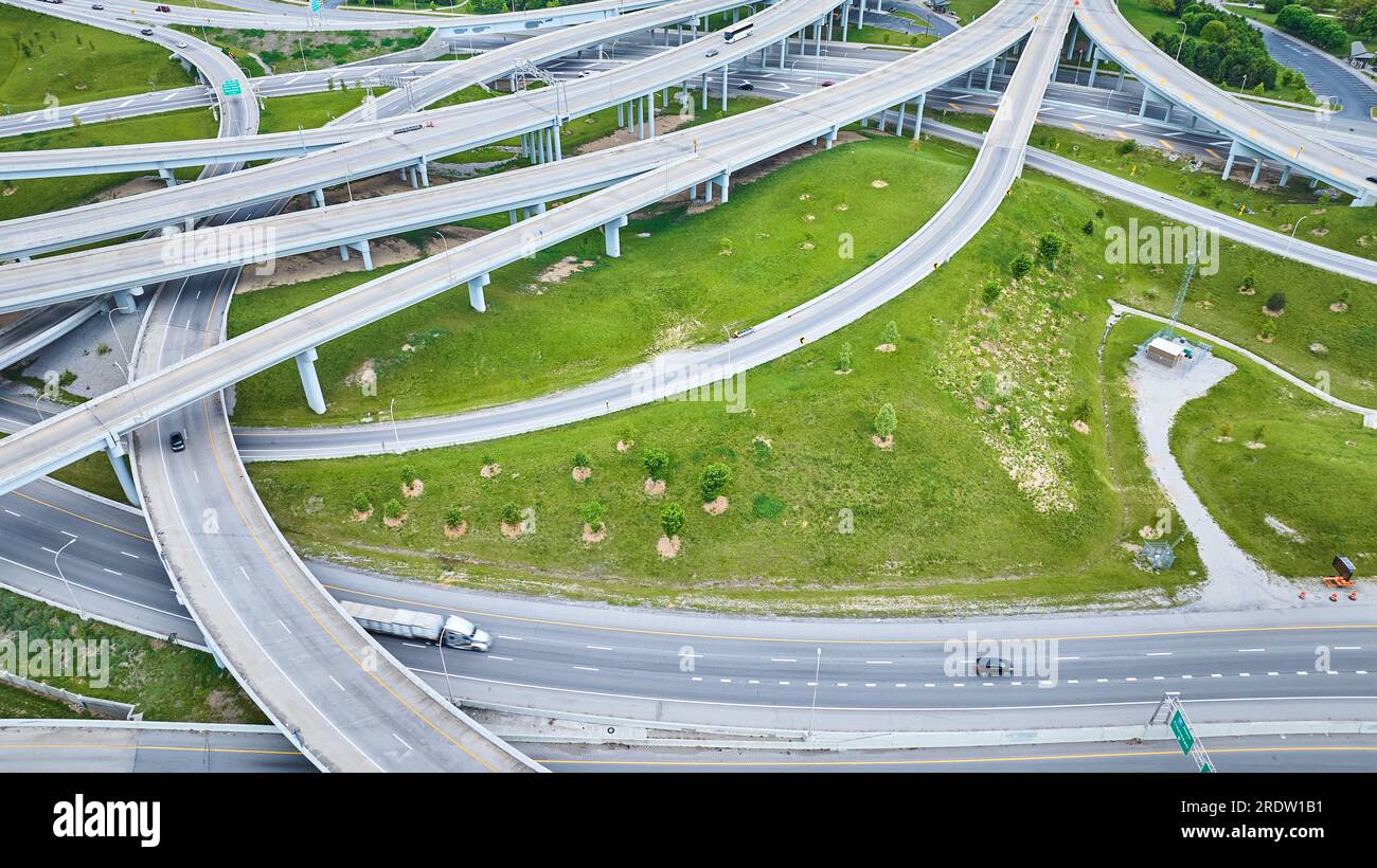 Greenery around looping highway suspended roads aerial Stock Photo - Alamy