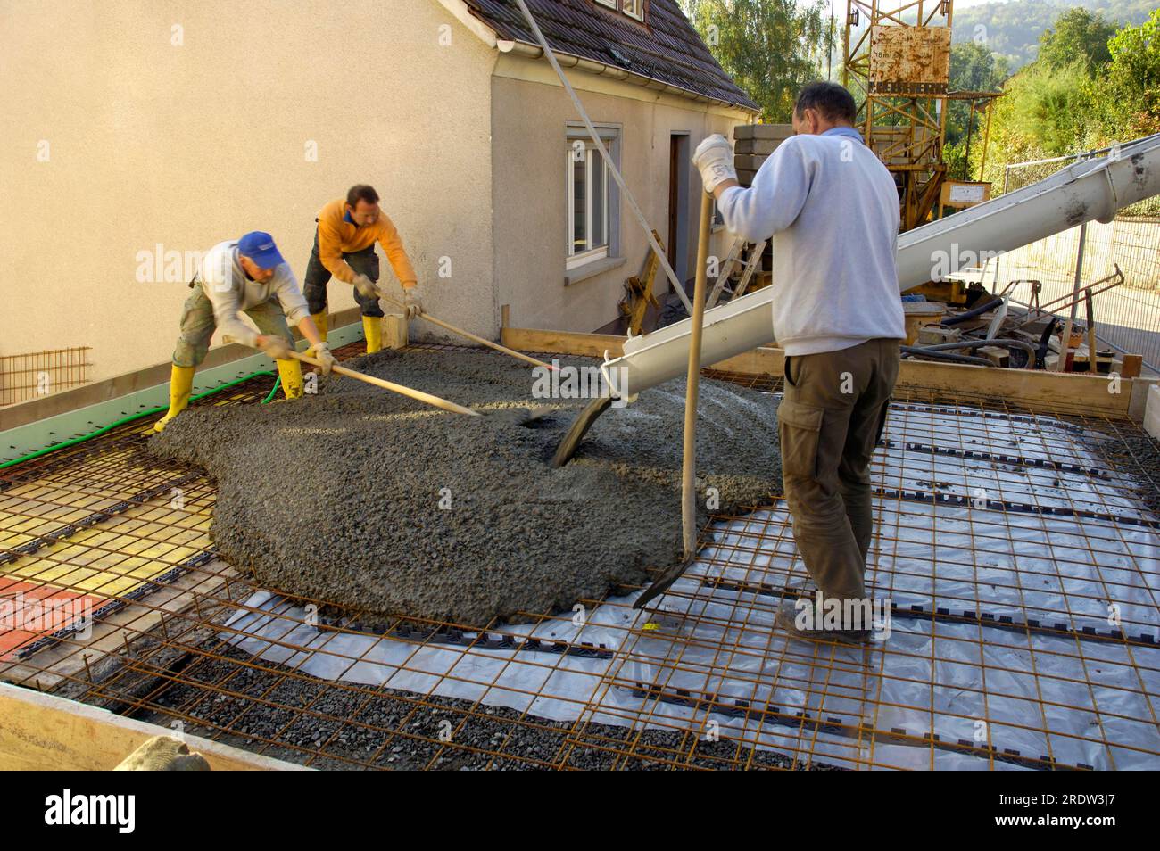 Men concreting, construction site, construction work, pouring concrete ...