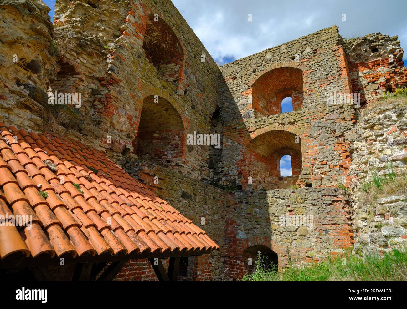 The walls of an old medieval castle. Collapsed walls preserved ...