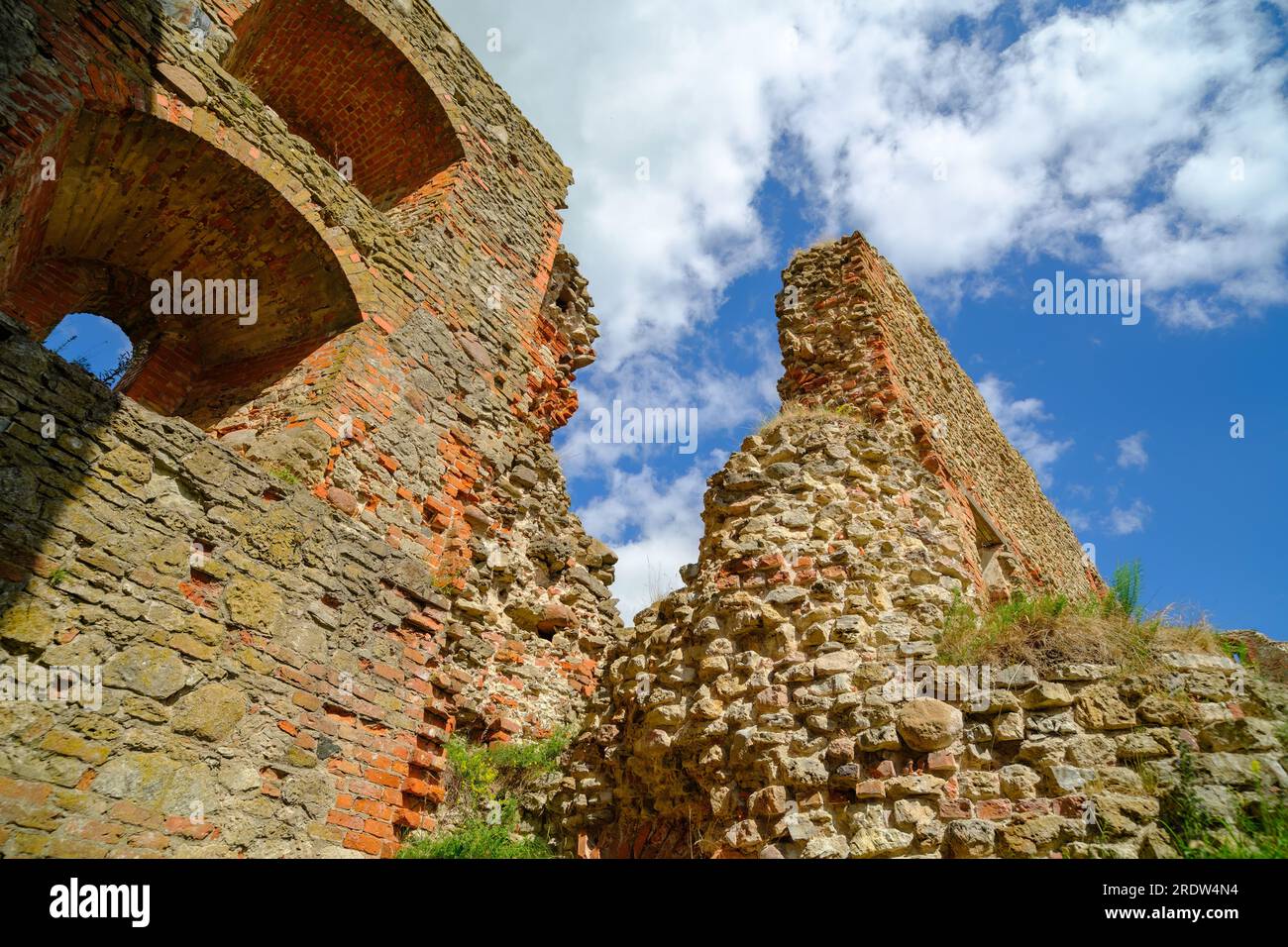 The walls of an old medieval castle. Collapsed walls preserved ...