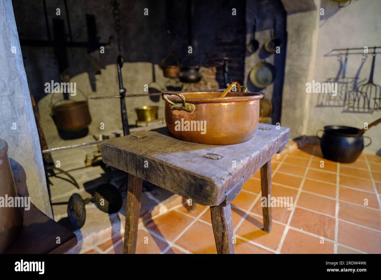 Ancient brass pots. Medieval kitchen metal cooking utensils. Interior ...