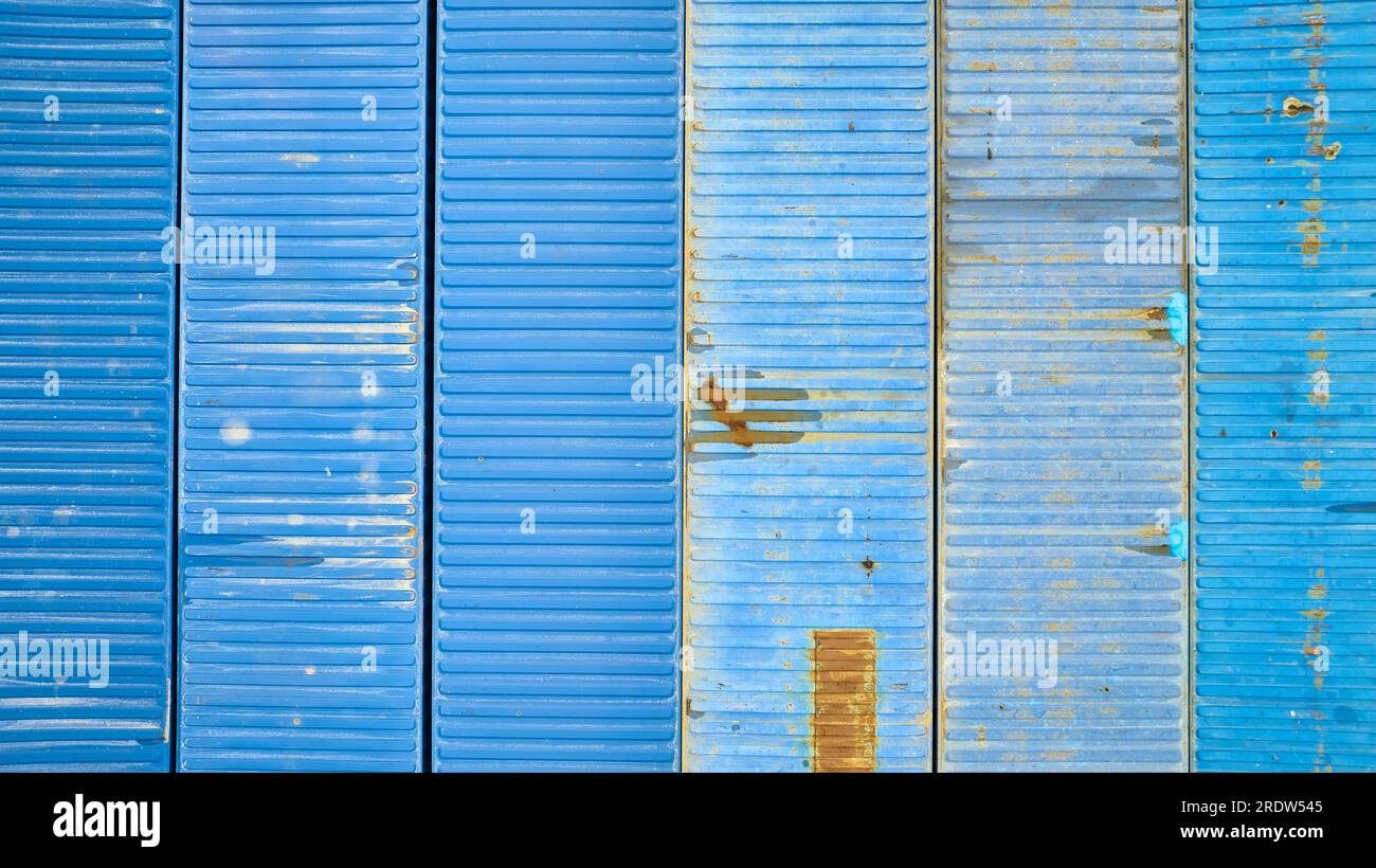 Wall of various pastel blue shipping containers aerial abstract ...