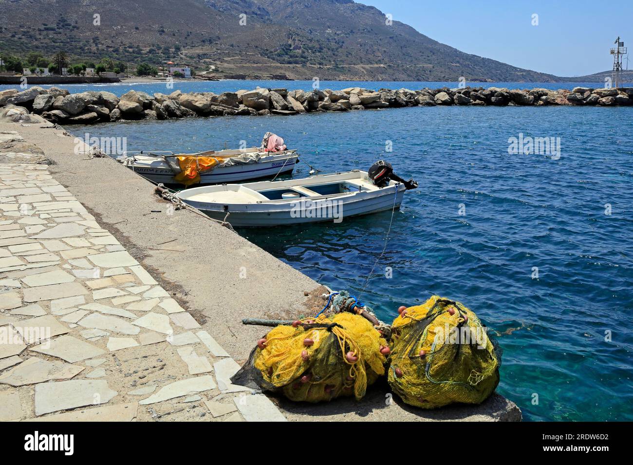 Greek fishing nets and boats at Agios Antonios harbour, Tlos island ...