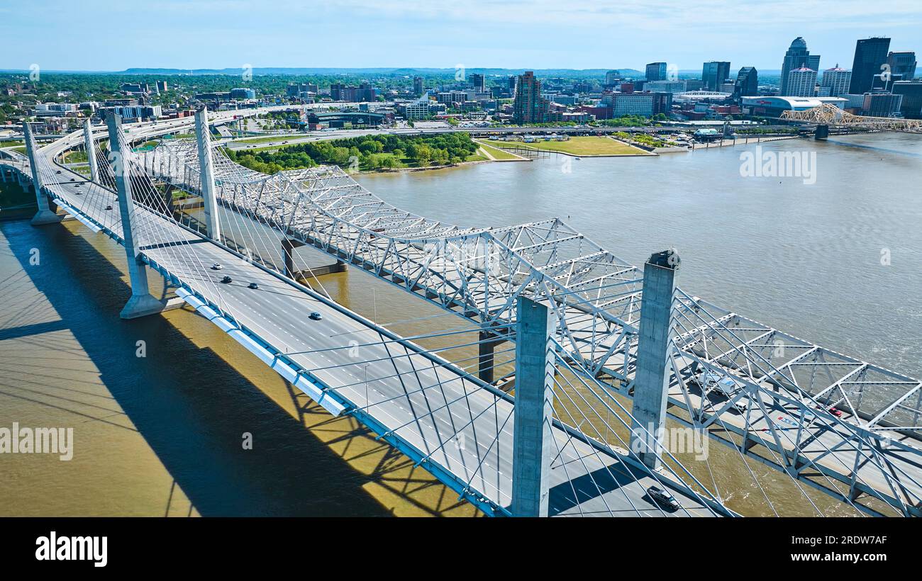 White suspension and truss bridges over dirty water of Ohio River ...