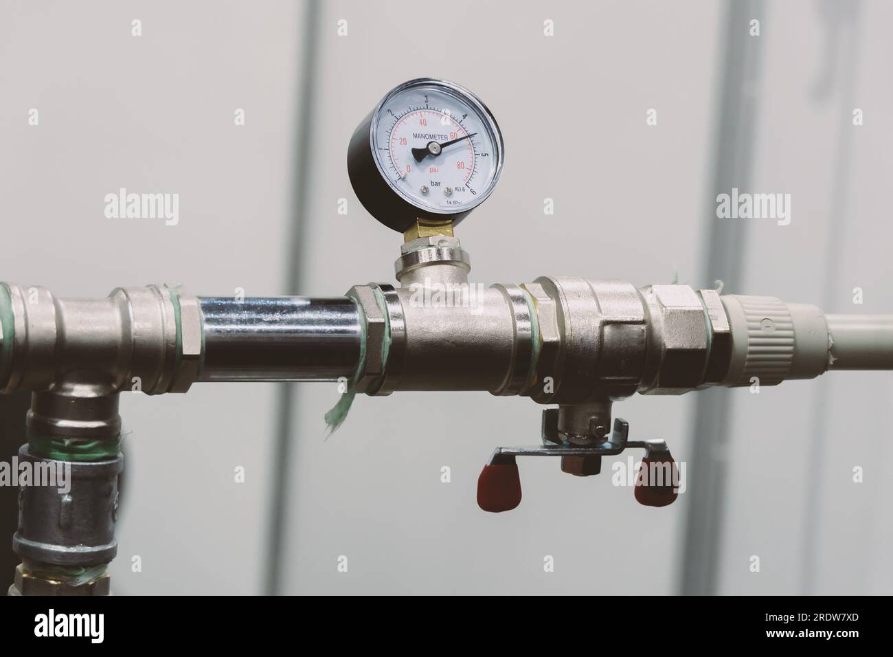 Tight connections of the ball valve on the pipe with a pressure gauge ...