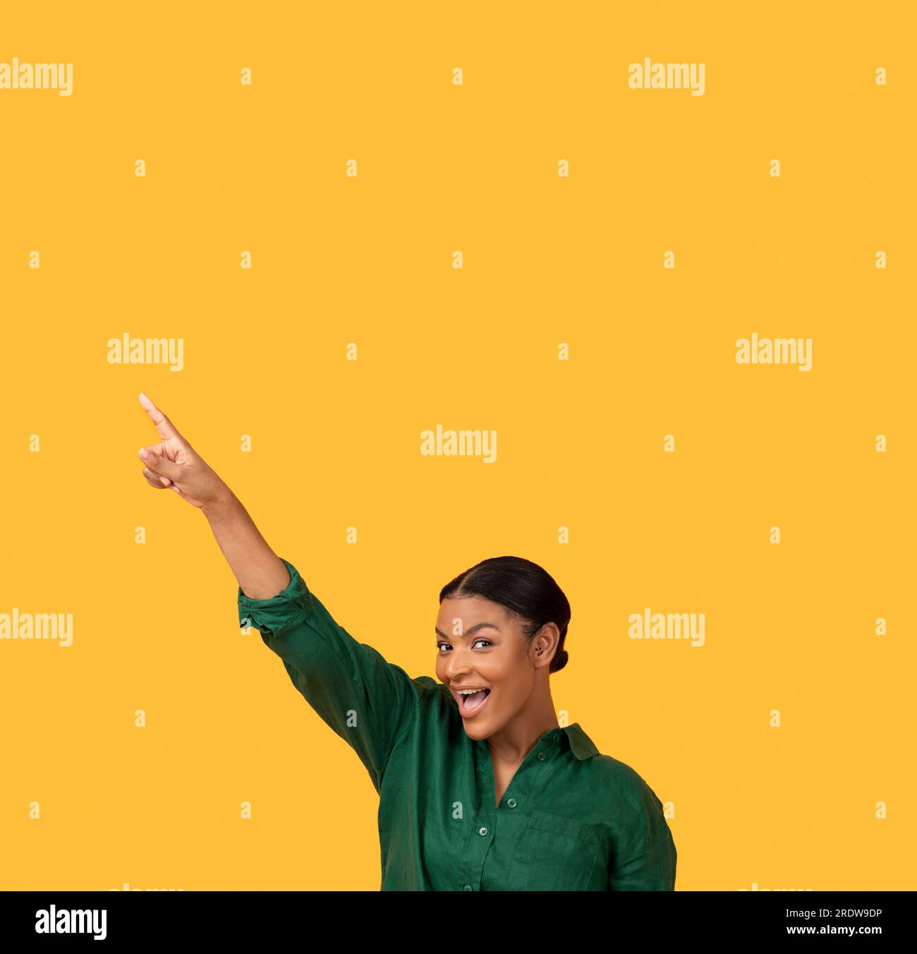 Excited African American Woman Pointing Finger Aside On Yellow ...