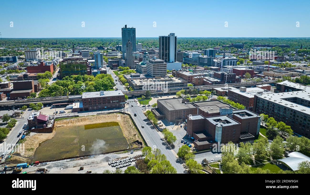 Aerial downtown Fort Wayne construction pit of water skyscraper skyline ...