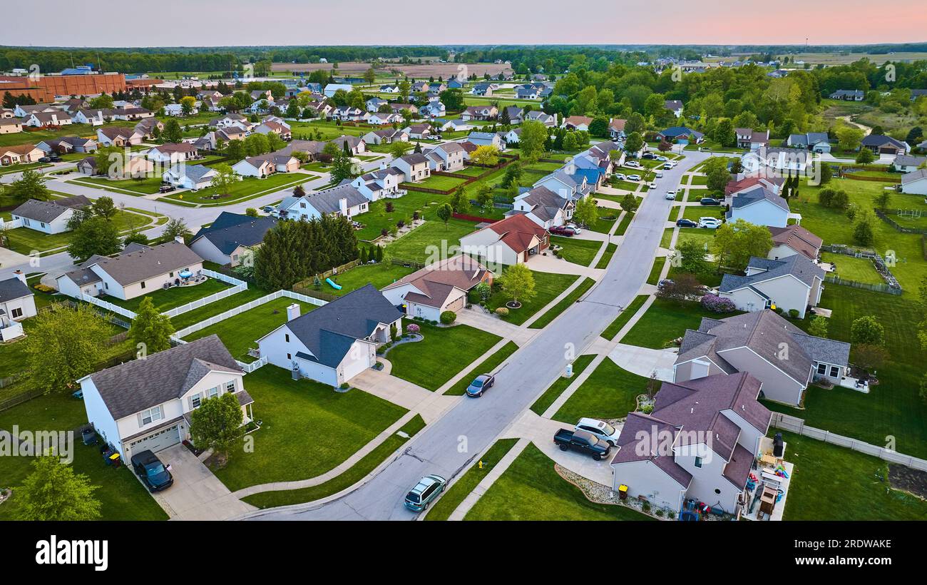 Pink sunset suburban homes neighborhood aerial HOA two-story and one ...