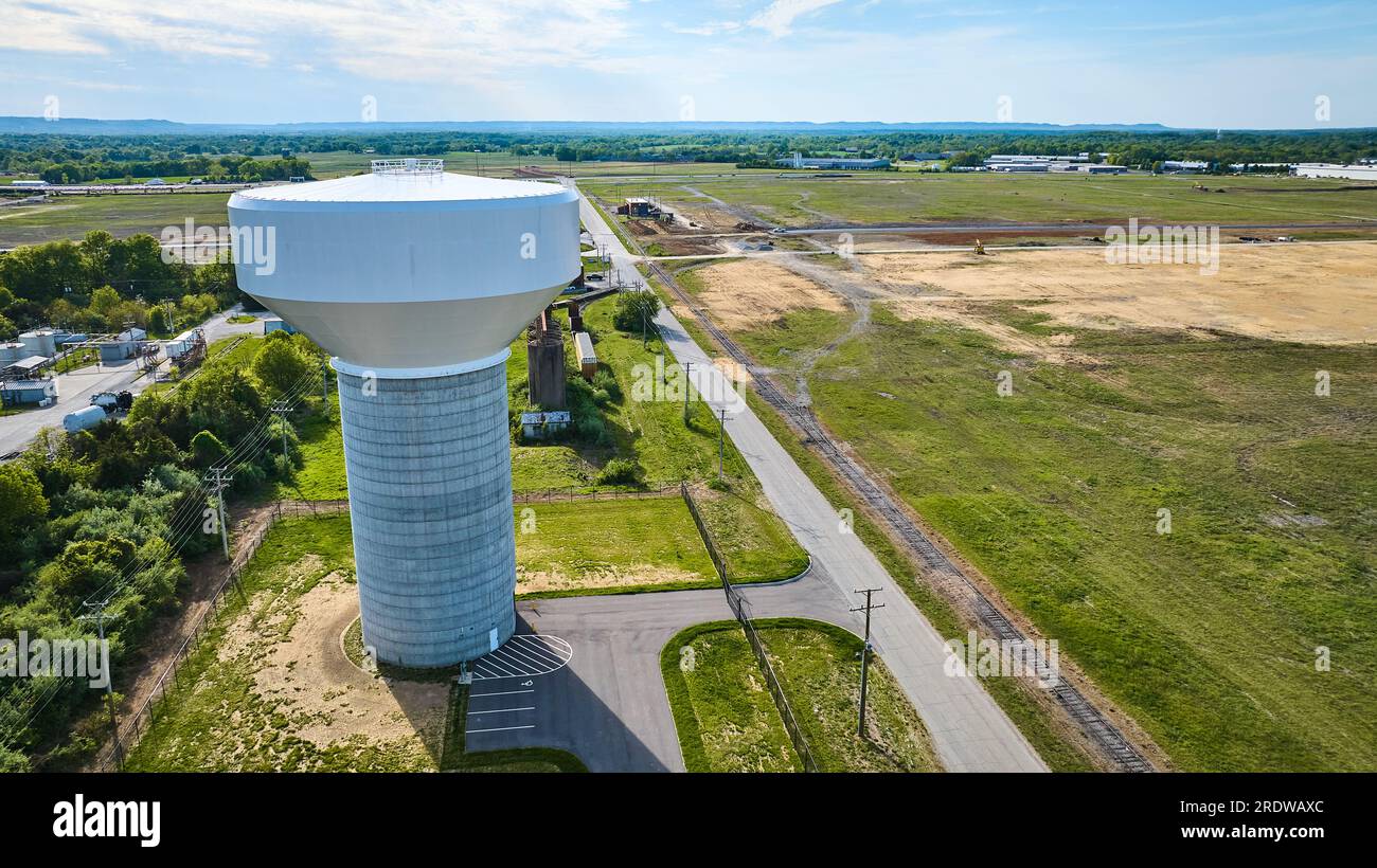 Aerial farmland farm fields, white water tower, abandoned buildings ...