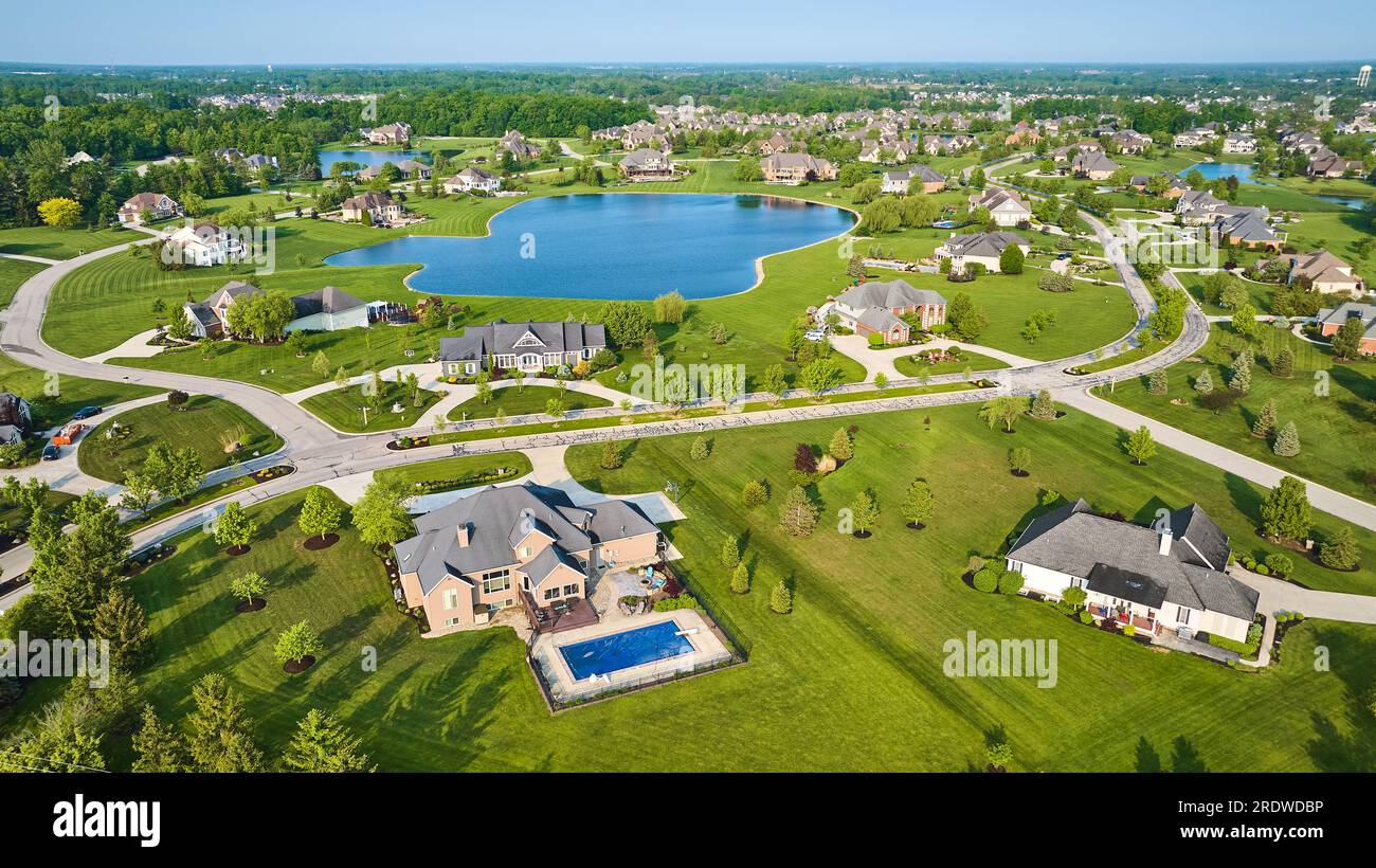 Pond with neighborhood of large mansion properties and inground pool ...