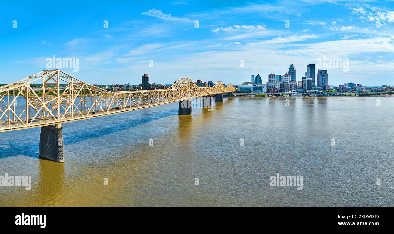 Panoramic aerial rose gold truss arch bridge over Ohio River leading to ...