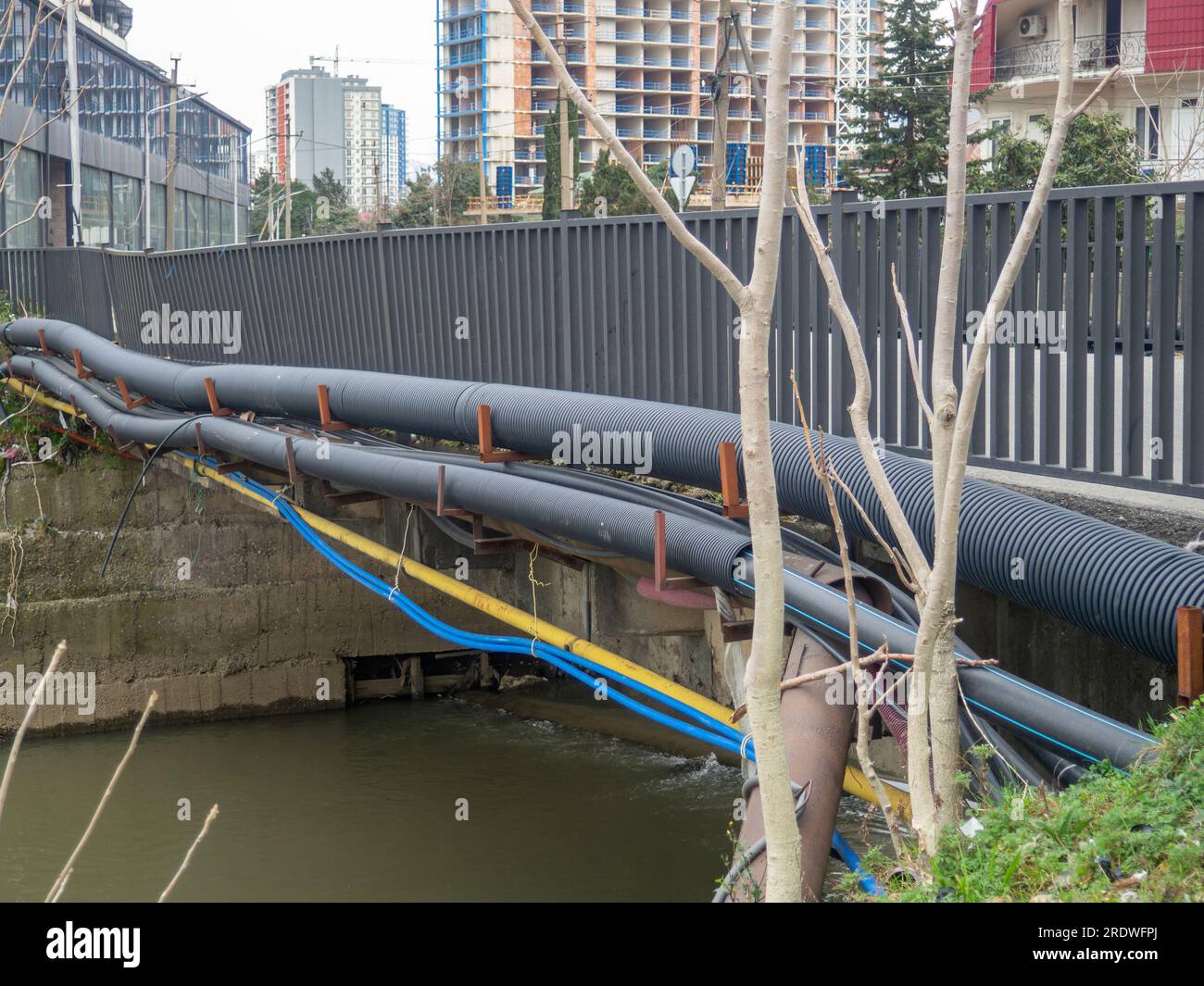 Communications go under the bridge on the river. Wires and pipes under ...