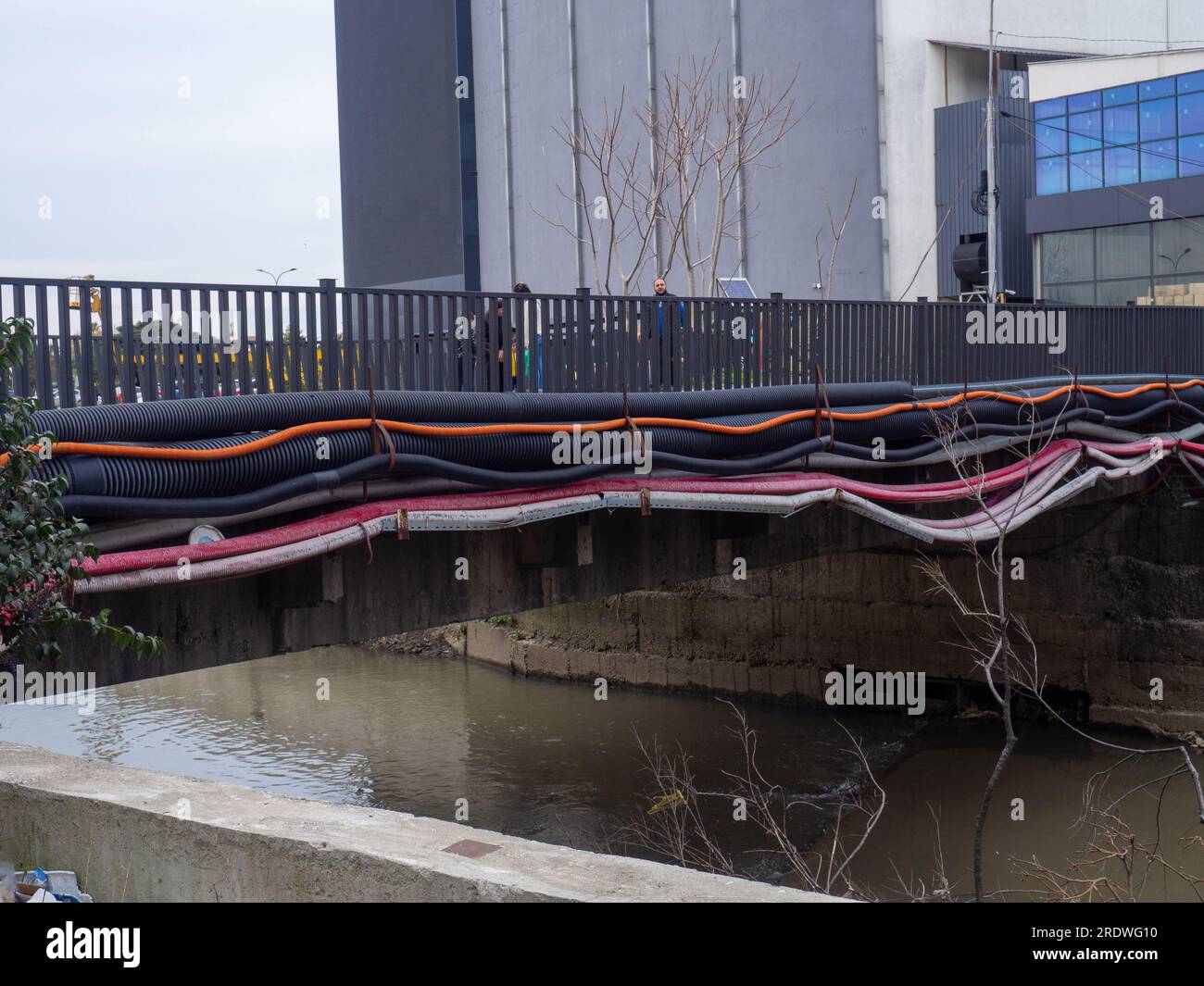 Communications go under the bridge on the river. Wires and pipes under ...