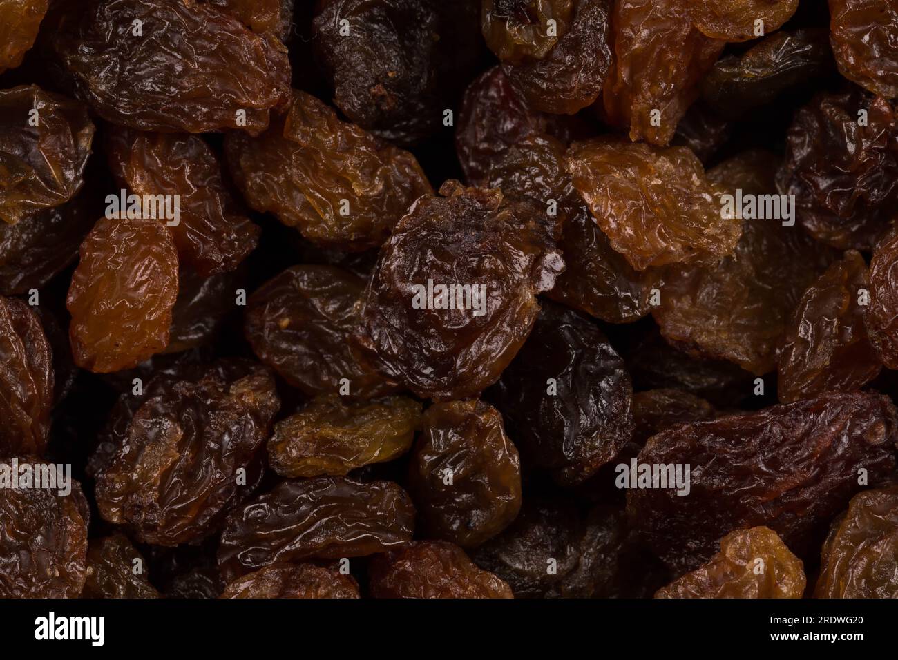 Sweet dry raisins close up shot for background Stock Photo - Alamy
