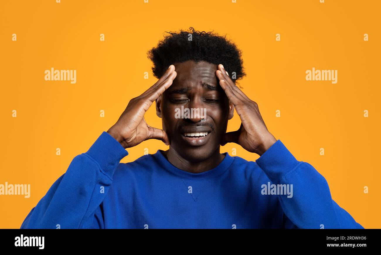 Stressed young african american man feel pain Stock Photo - Alamy