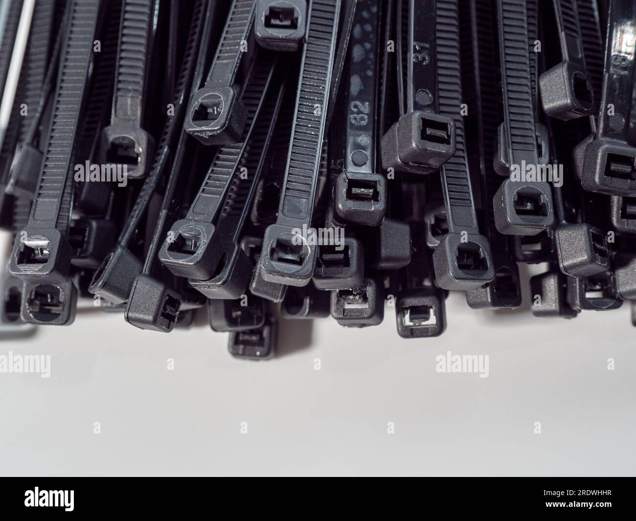 Plastic black ties on a white background. Plastic ties for cables Stock ...