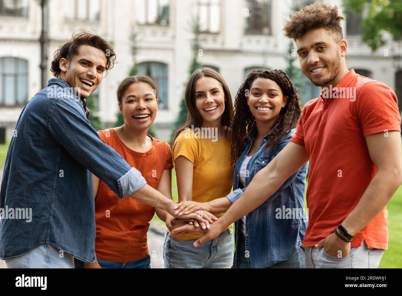 Group school friends joining hi-res stock photography and images - Alamy