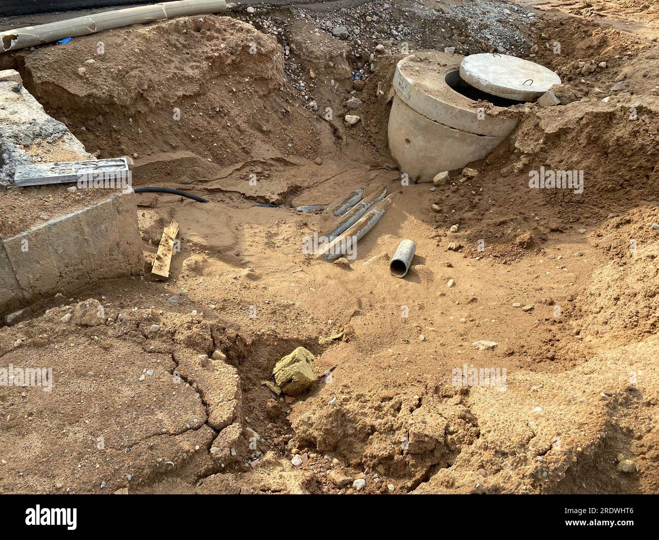 Concrete manhole in a pit at a construction site. Industrial ...