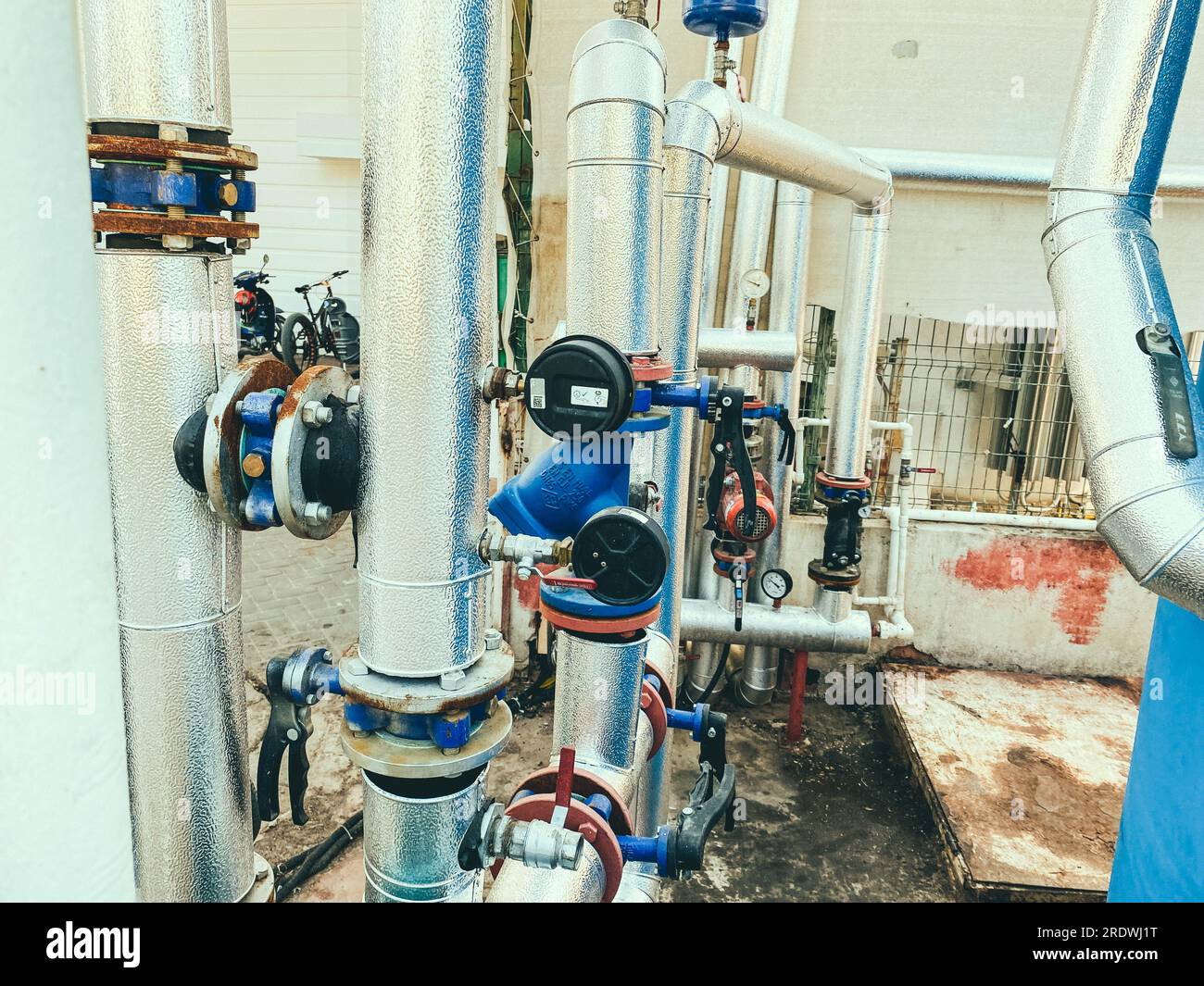 utility room. gray metal structures. on designs of blue valves with red ...