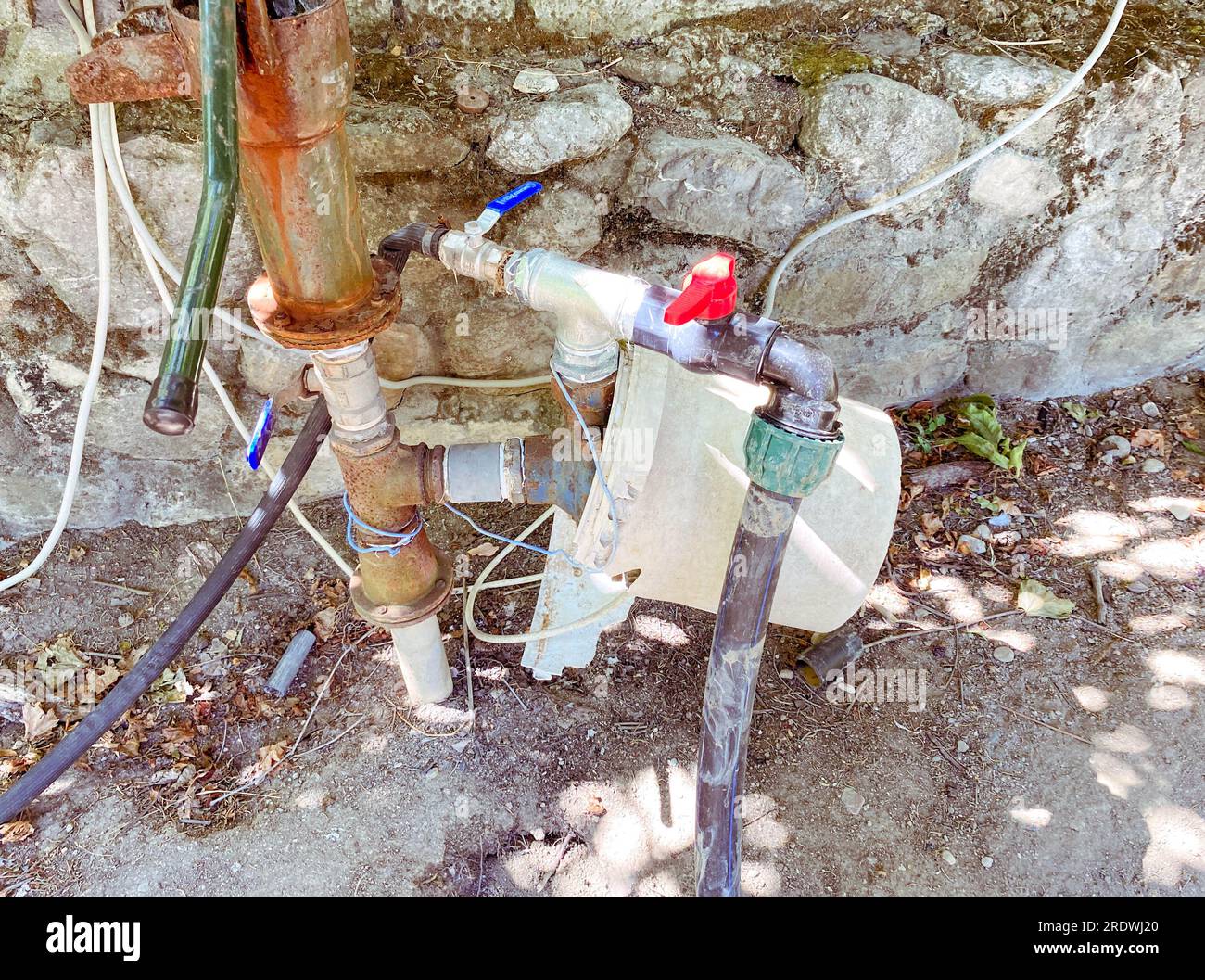 extraction of water from underground sources. white plastic bottles are ...