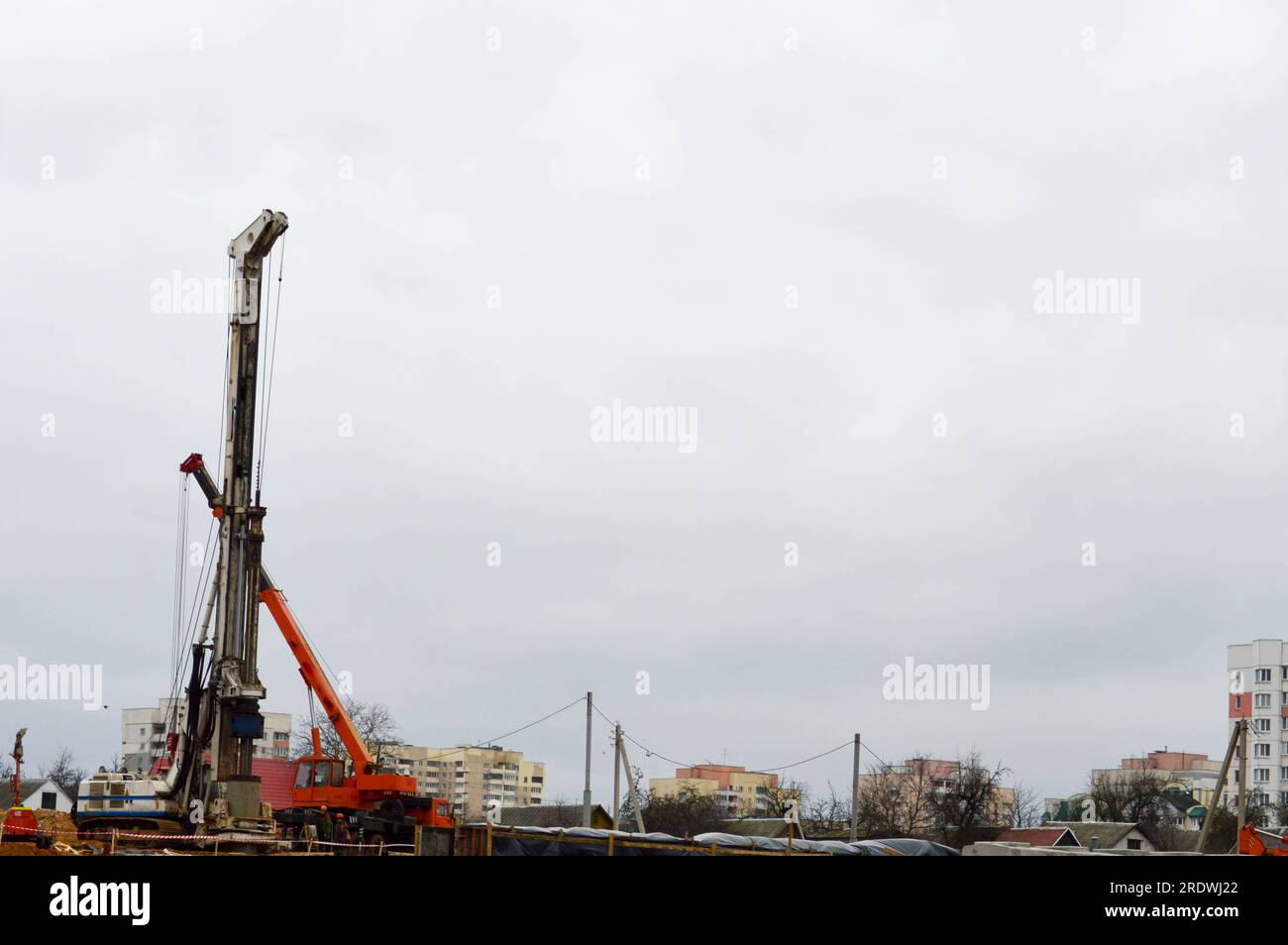 A large powerful iron pile driver, an industrial construction machine ...