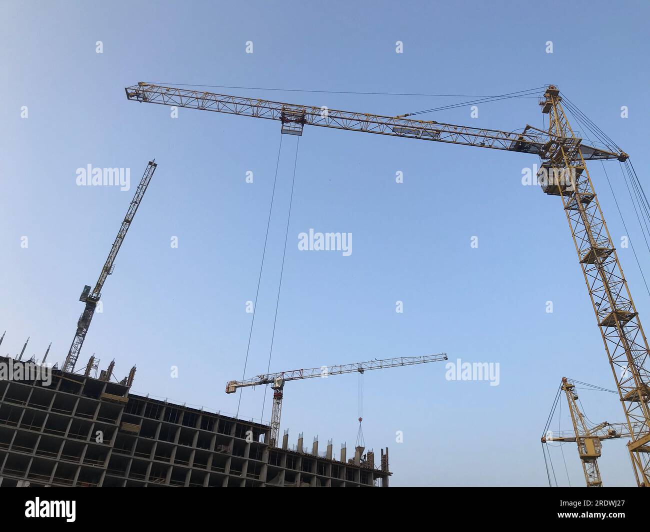 construction crane on a background of blue sky. crane for moving heavy ...