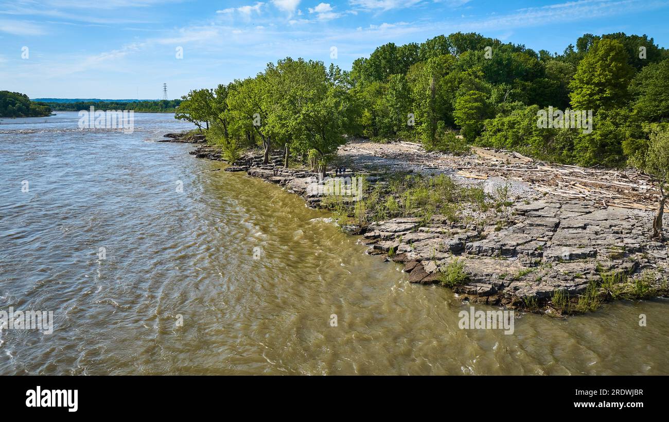 River flowing around limestone shore with green summer trees aerial ...