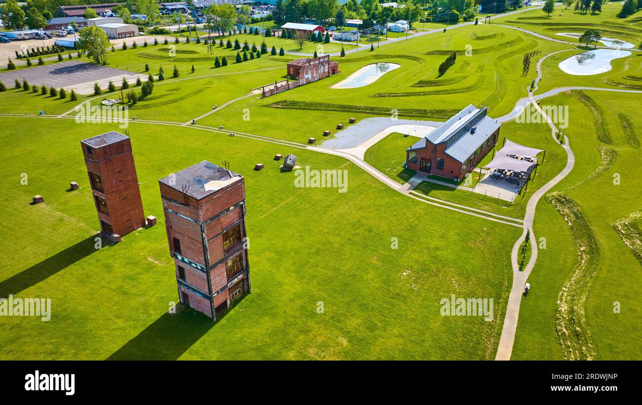 Aerial of lush green grass at Ariel Foundation Park and its factory ...
