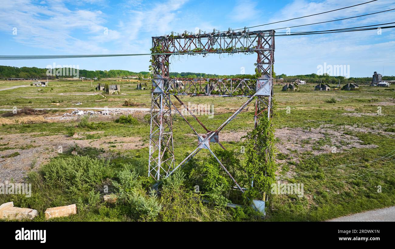 Green ivy vines climbing rusty rusting radio tower or power cables near ...
