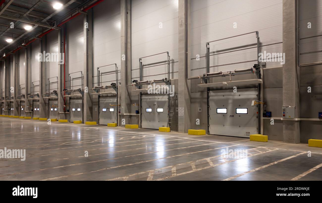 truck at loading ramps of a warehouse. Delivery logistics concept ...