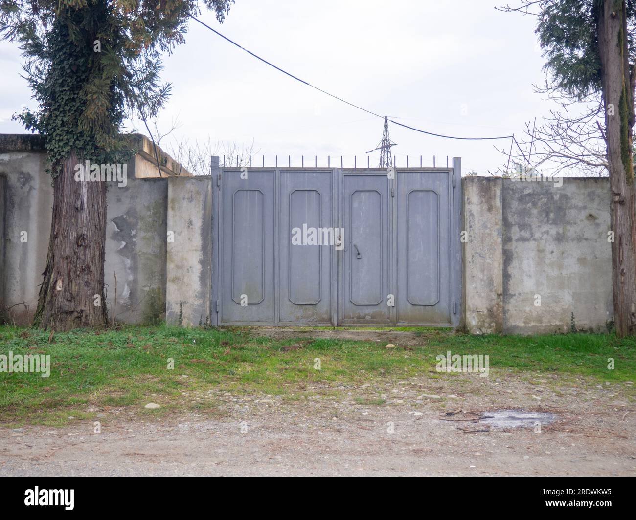 Locked gray gate. Private territory. Closed for entry. Fence with gate ...