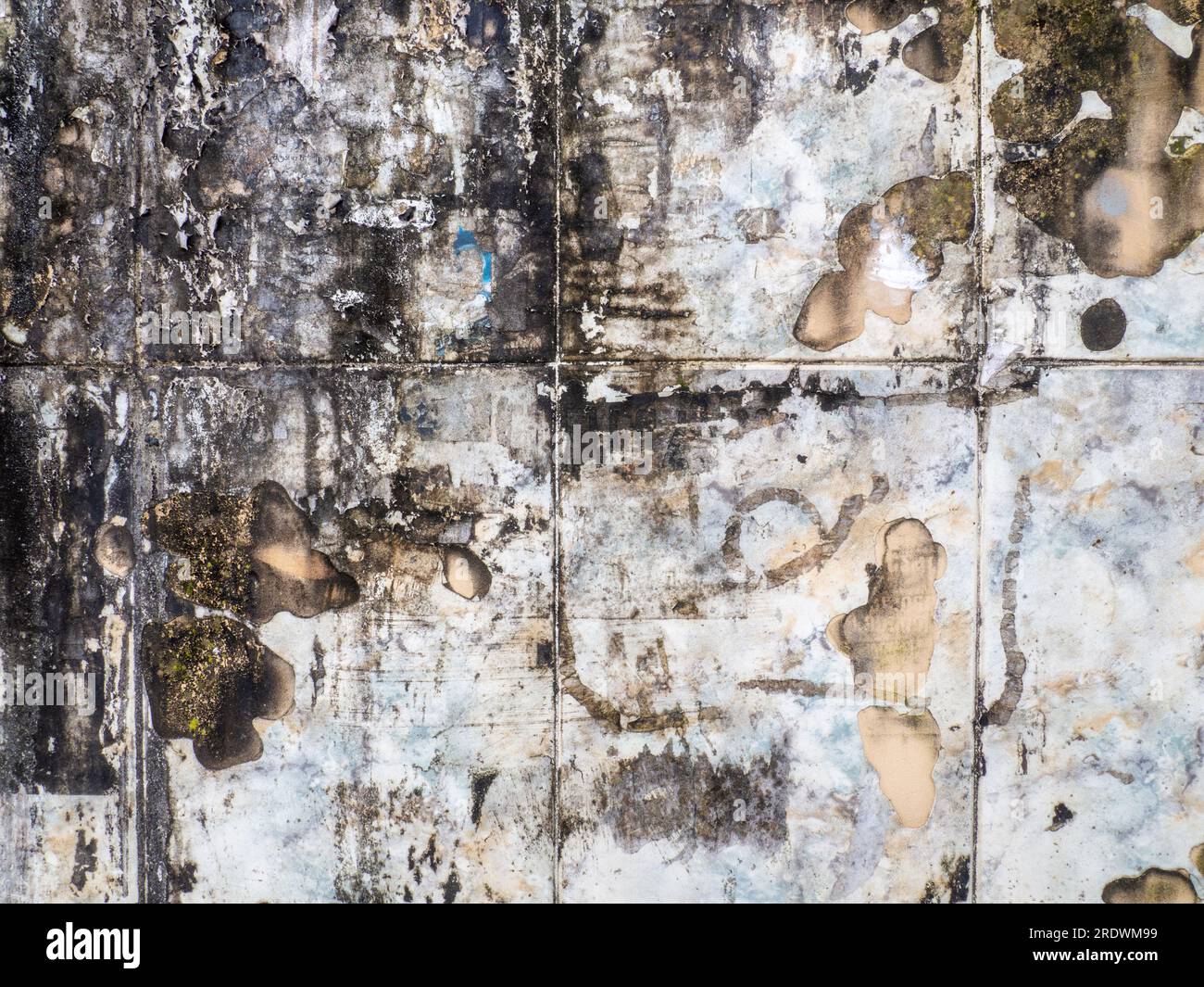 Background from a shabby wall. Old white cracked tiles. Blackened tiles ...