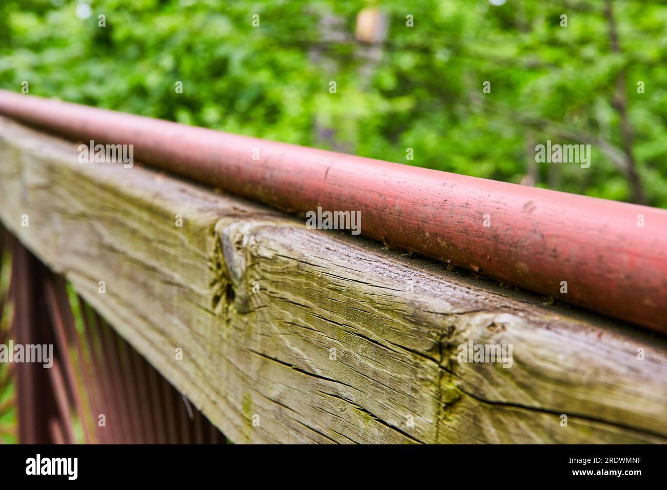 Macro close up of wood grains and split in beam with painted red pole ...