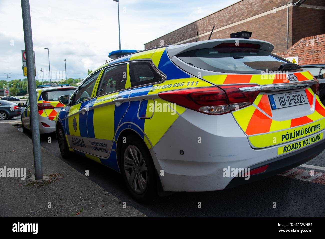 View of police emblems in Ireland, emblem on building, car, and street ...