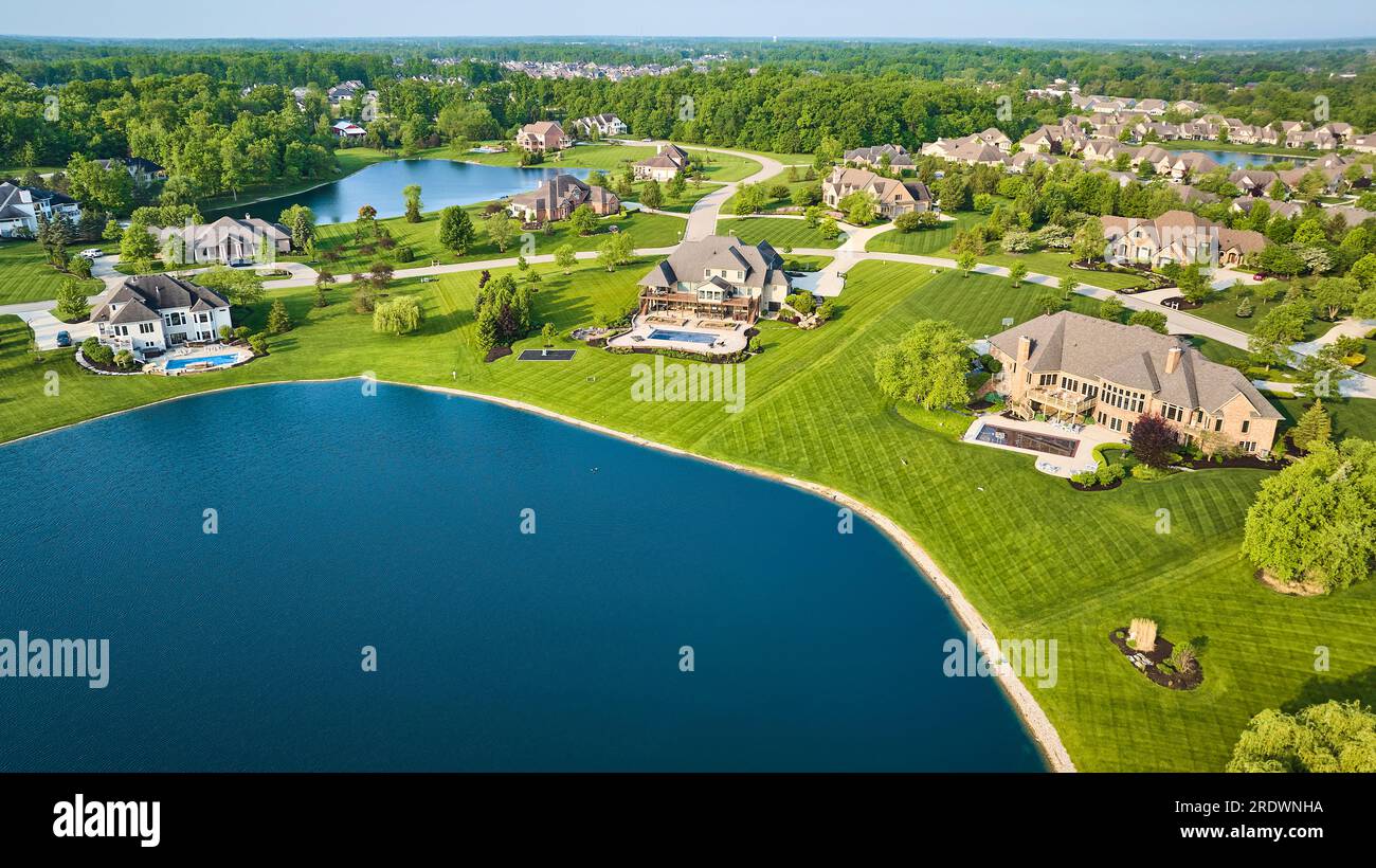 Aerial large pond lakeside properties rich expensive homes with three ...